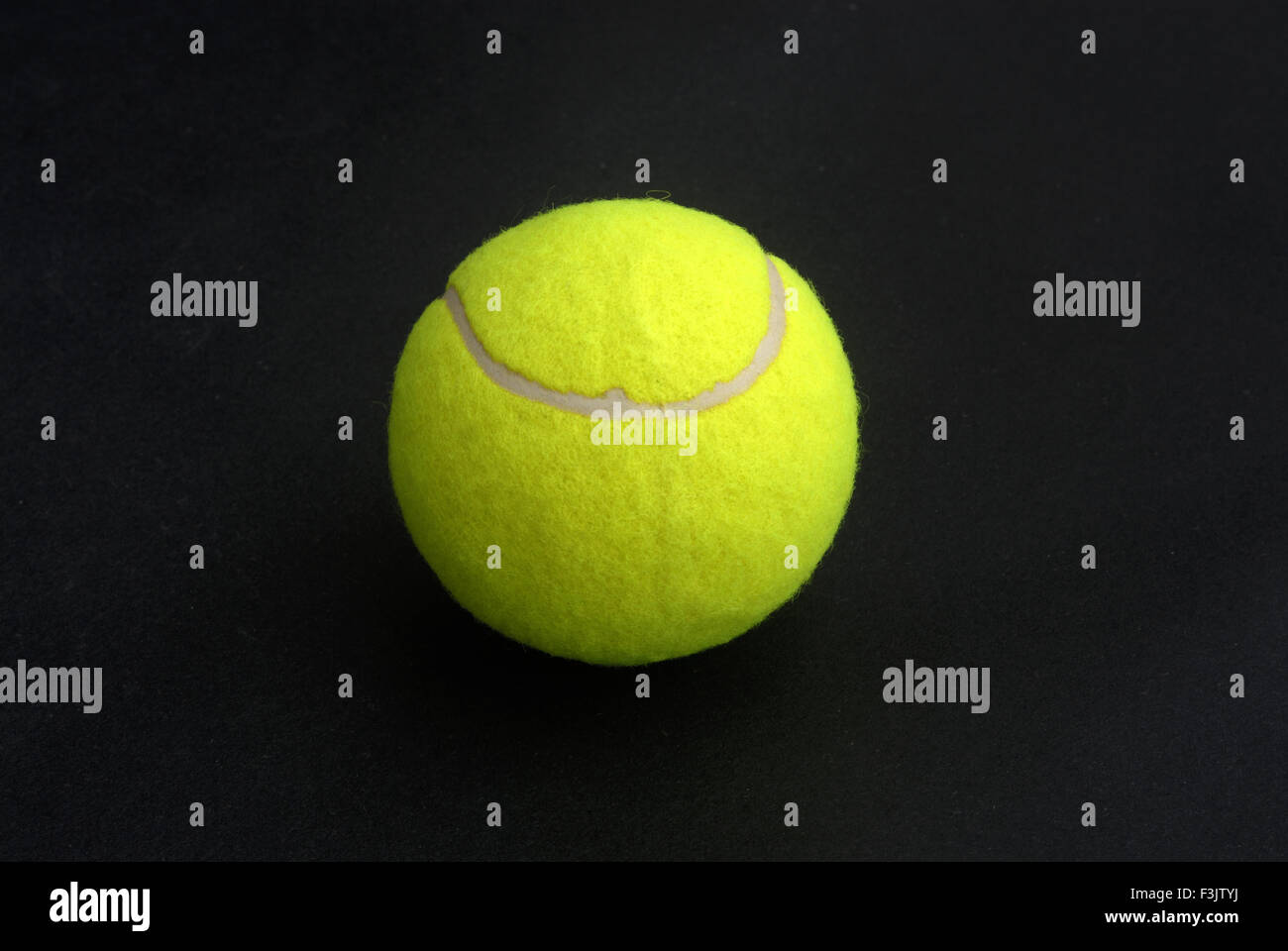 green Tennis ball on black background Stock Photo - Alamy