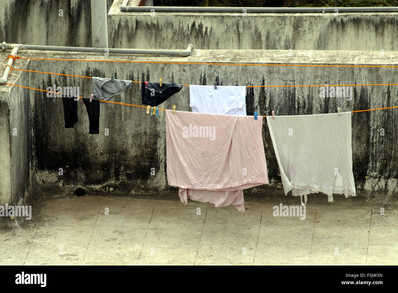 Clothes drying on nylon string on terrace at Pune ; Maharashtra ; India ...