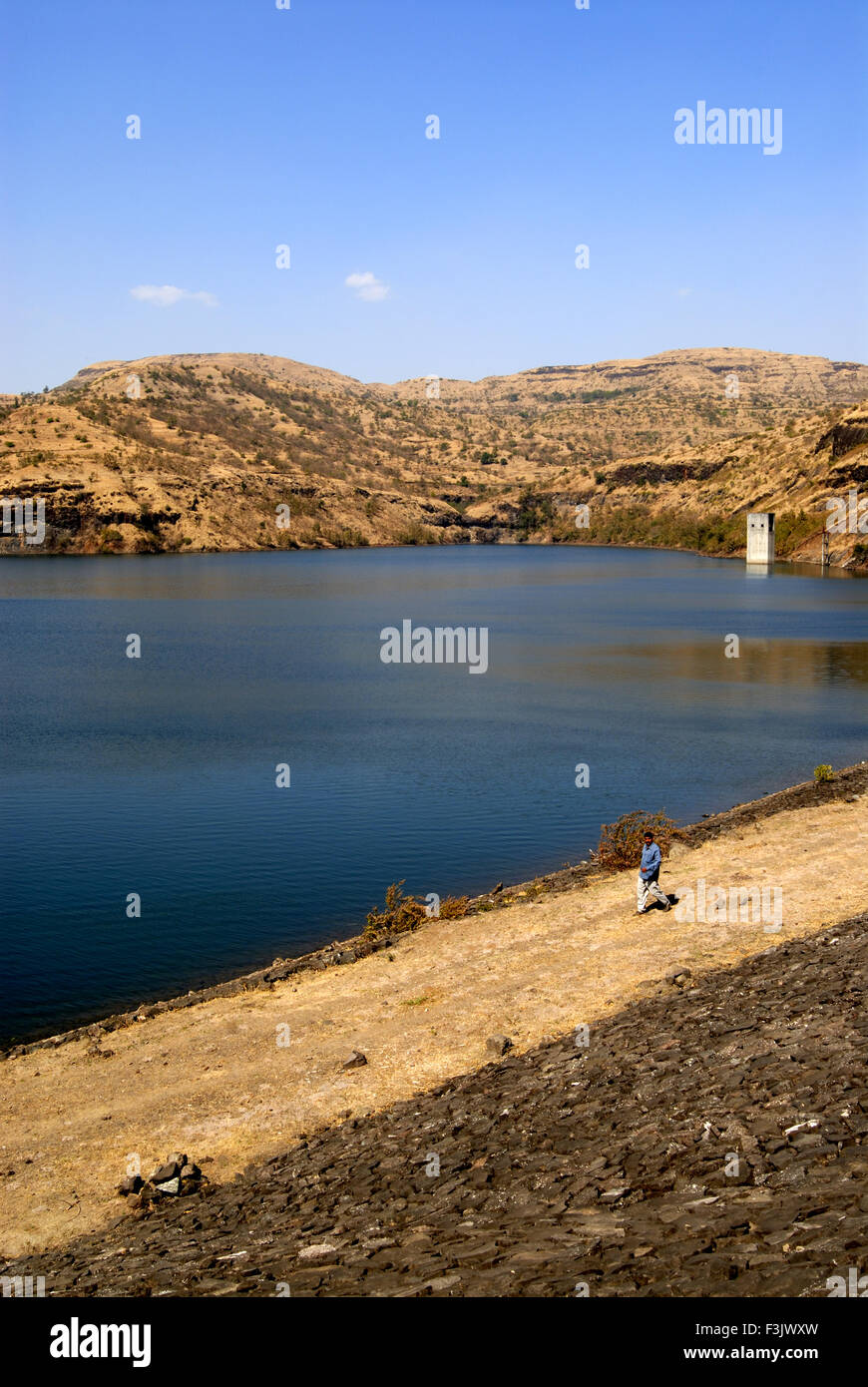 Earthen dam with stone pitching constructed between rock mountains at ...