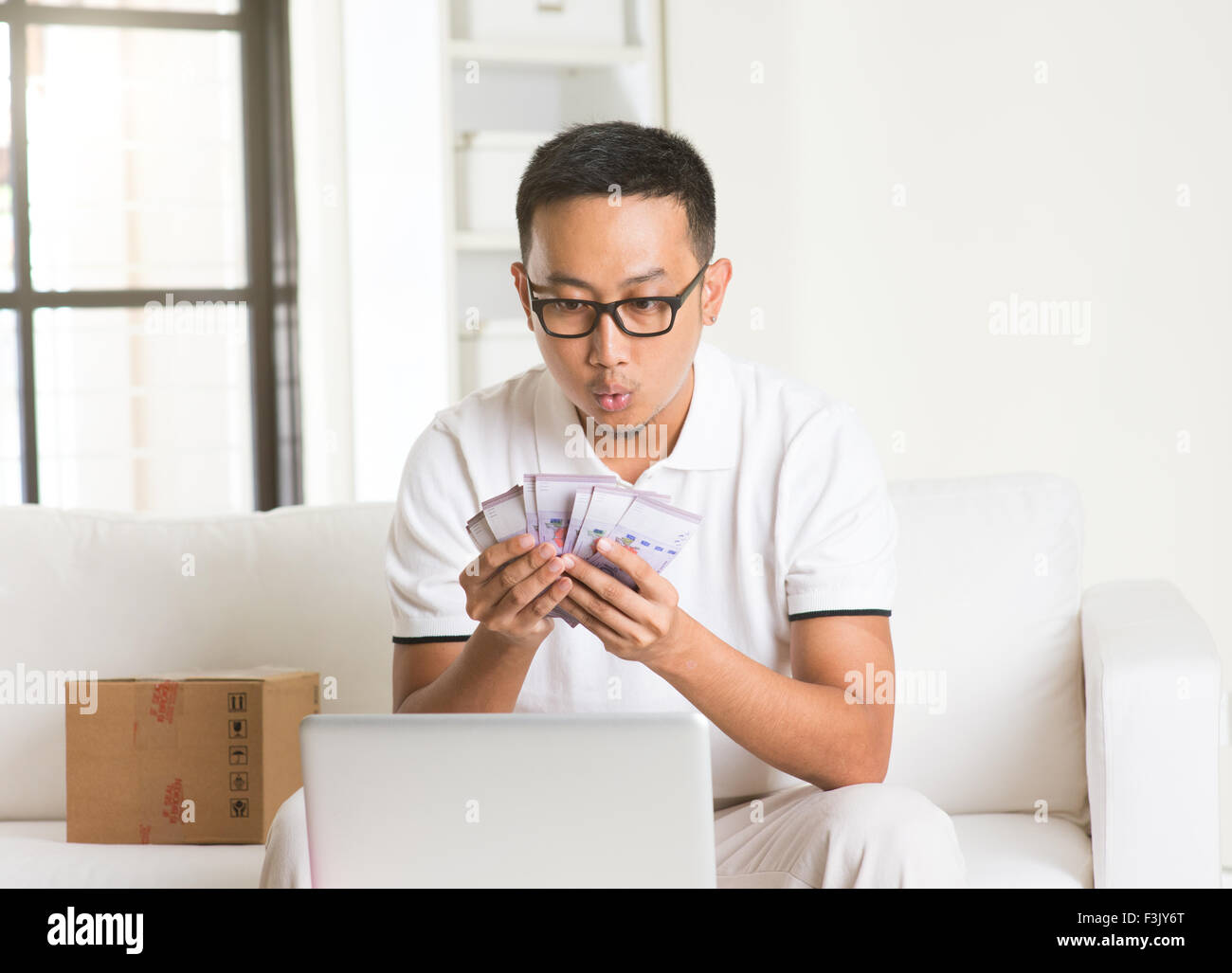 asian man earning cash from Internet Stock Photo - Alamy