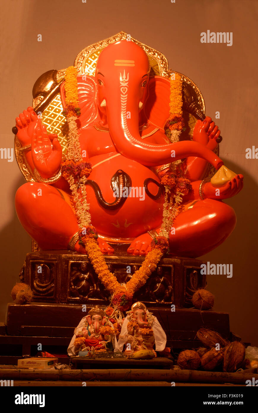 Richly decorated scarlet color idol Lord Ganesh elephant headed God ...