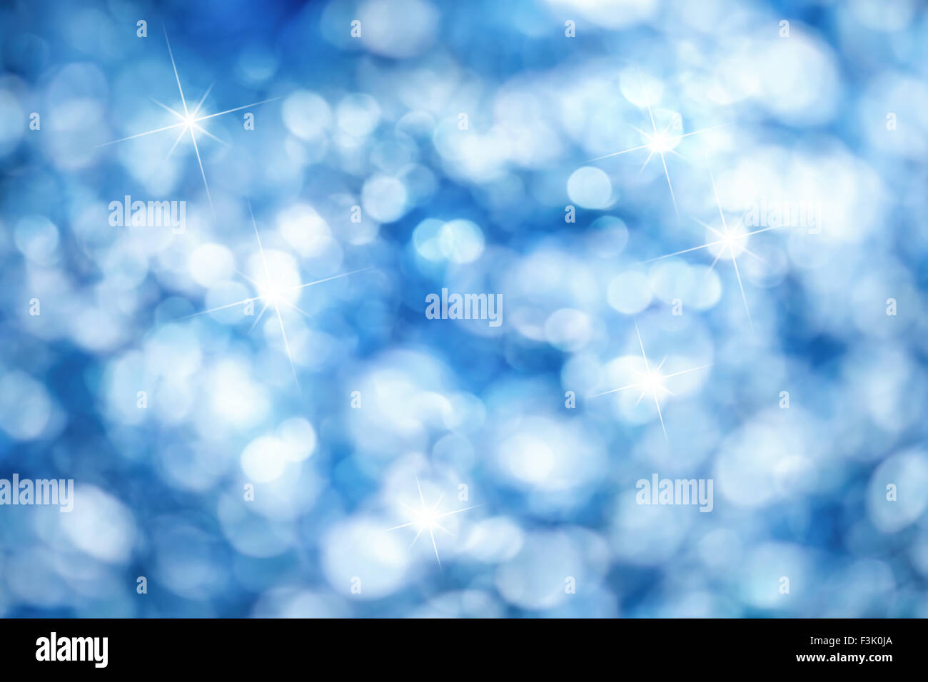 Out of focus lights creating a blue bokeh background with bright ...