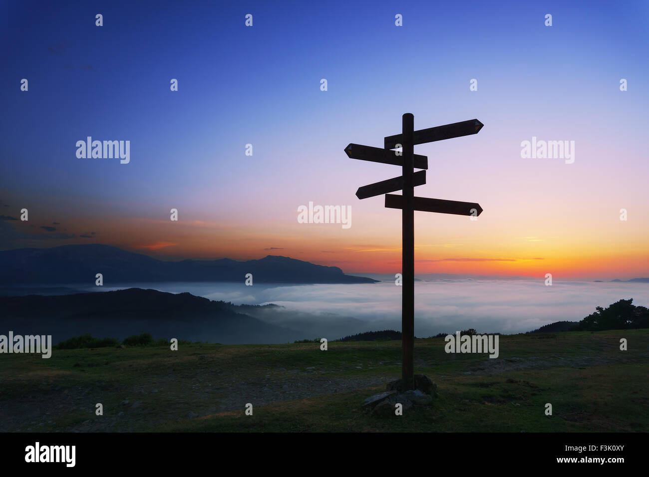 wooden signpost on mountain at sunset Stock Photo - Alamy