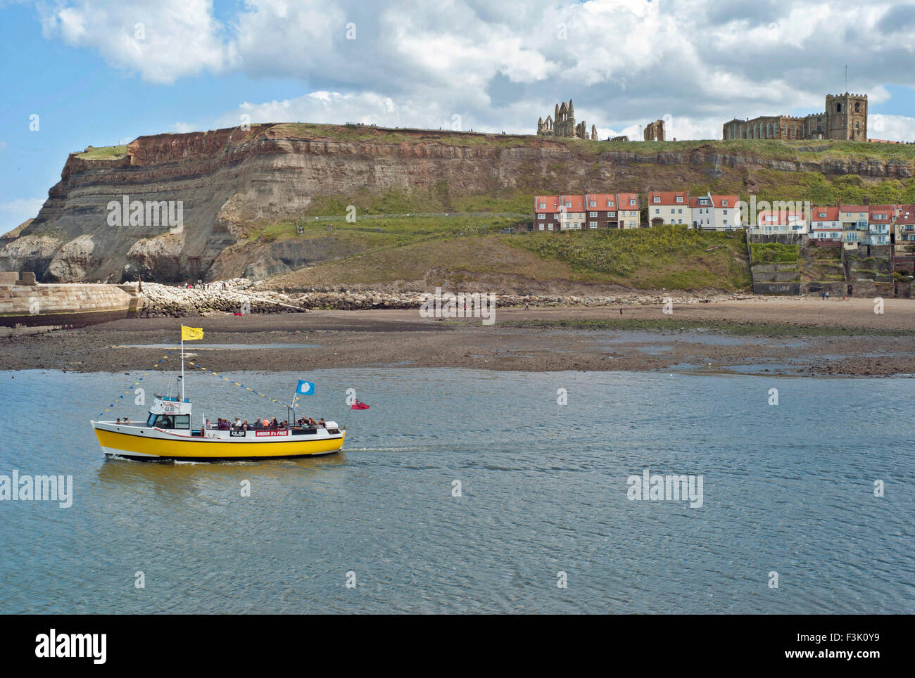 Whitby, North Yorkshire, pleasure boat foreground,Whitby Abbey stands ...