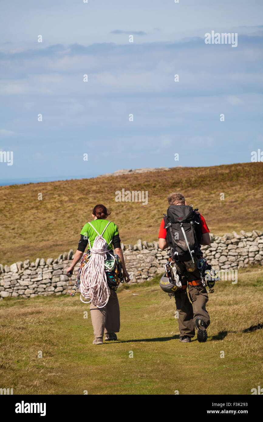 Rock climbers walking with their equipment to do some rock climbing at ...