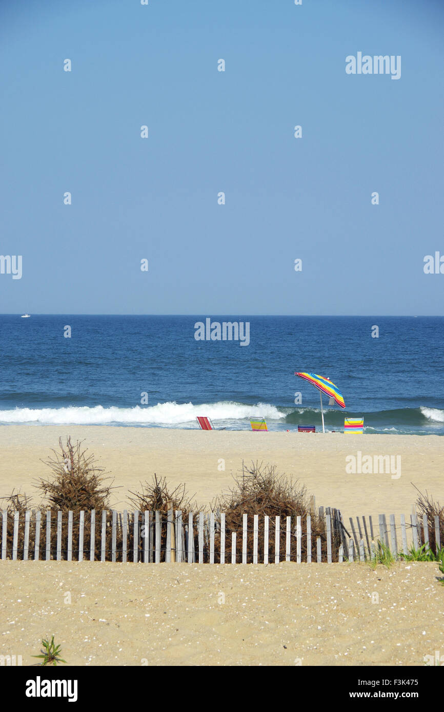 Landscape with ocean view sand dunes and beach chairs and umbrella ...