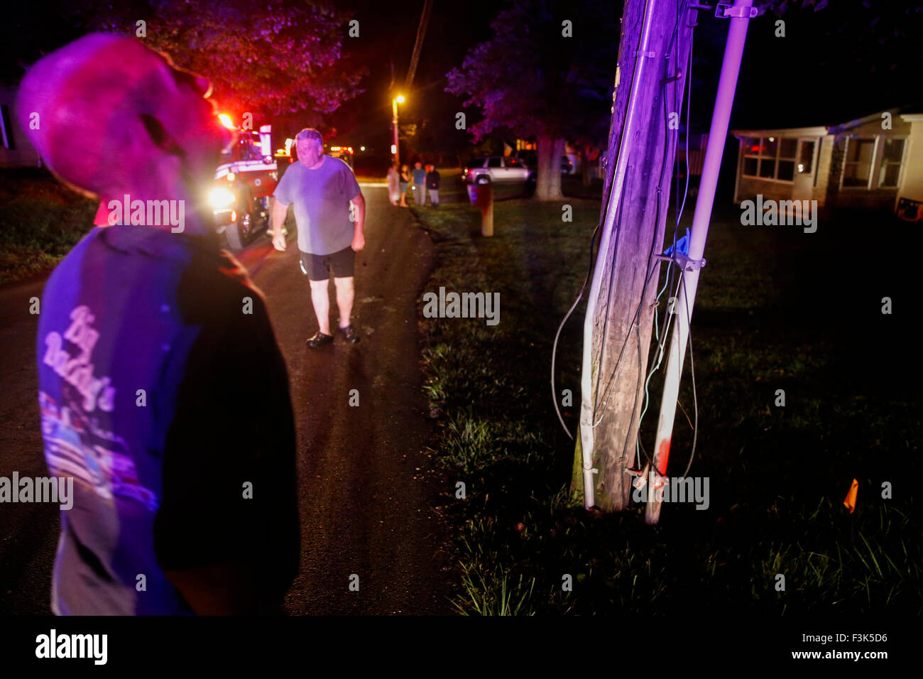 Residents at a telephone utility pole hit at the scene of a single ...