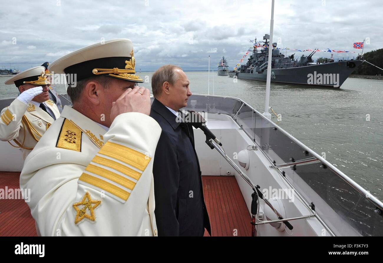 Russian President Vladimir Putin reviews a Navy parade alongside ...