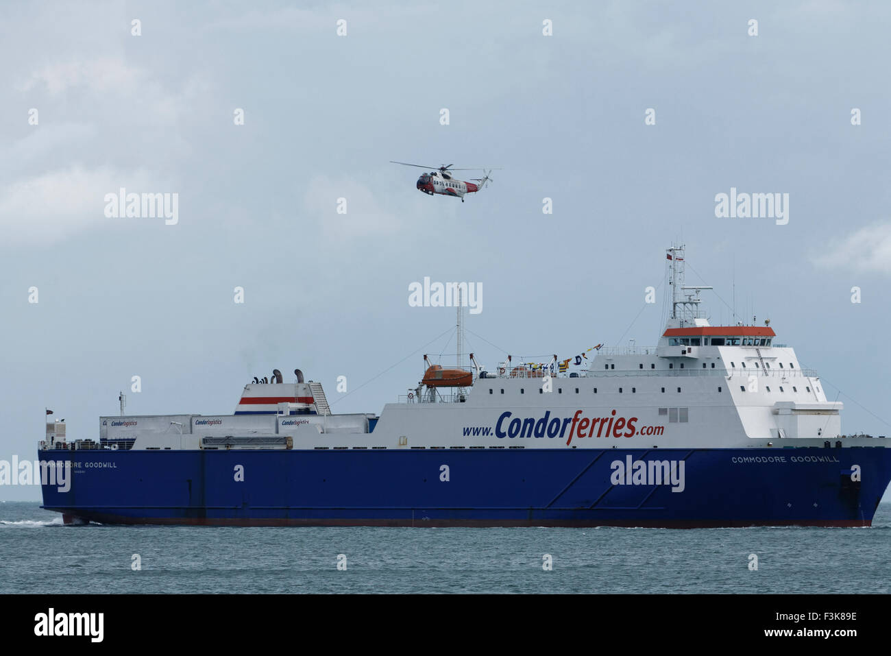 Condor ferry with H.M Coastguard search and rescue helicopter flying in ...