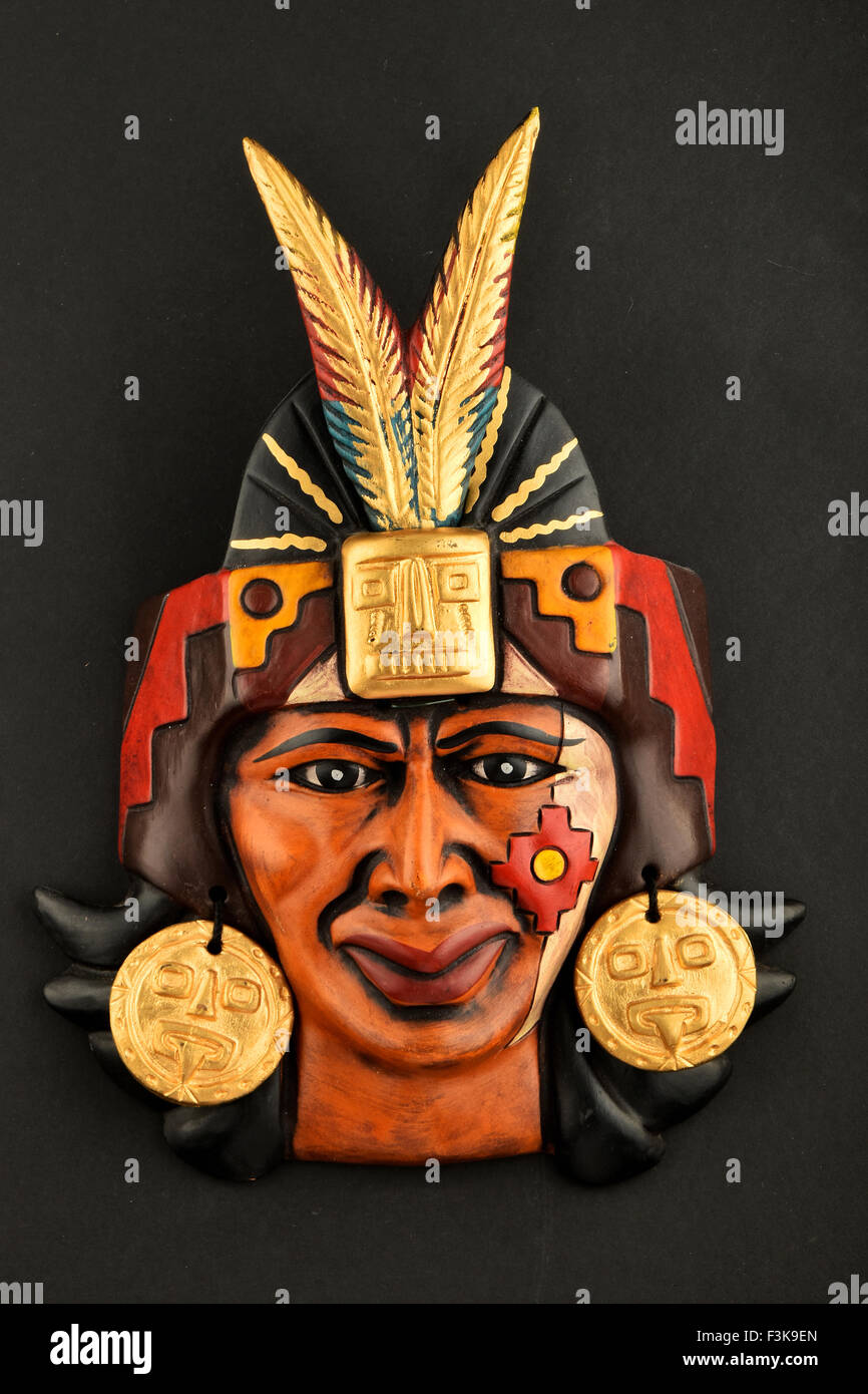 Indian Mayan Aztec ceramic mask with feather isolated on black paper ...