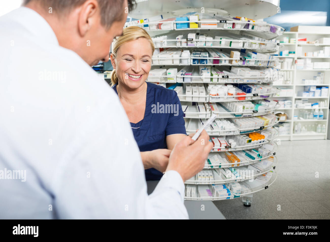 Pharmacist Explaining Product Details To Male Customer Stock Photo - Alamy