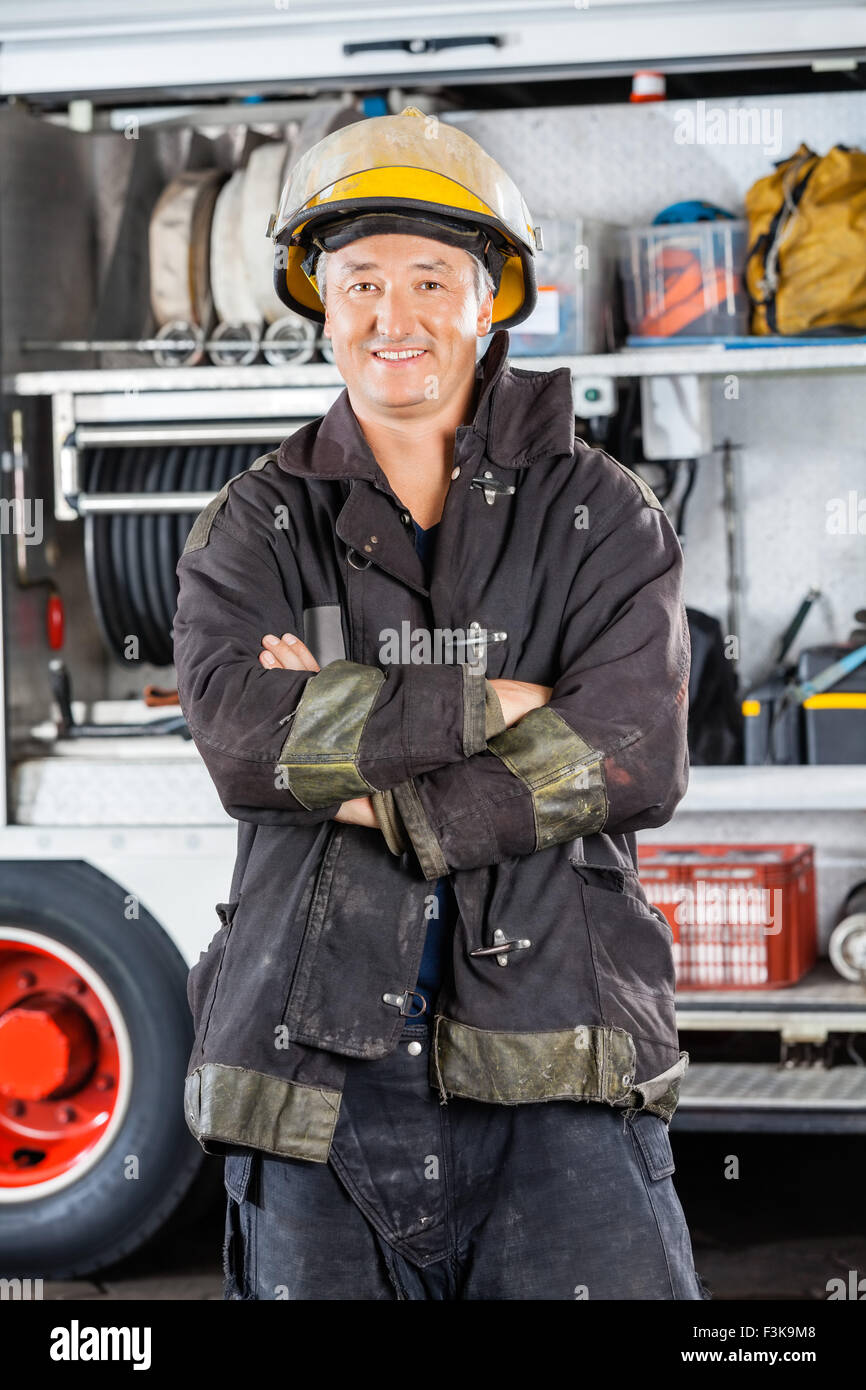 Mature Firefighter Standing Arms Crossed Against Firetruck Stock Photo ...