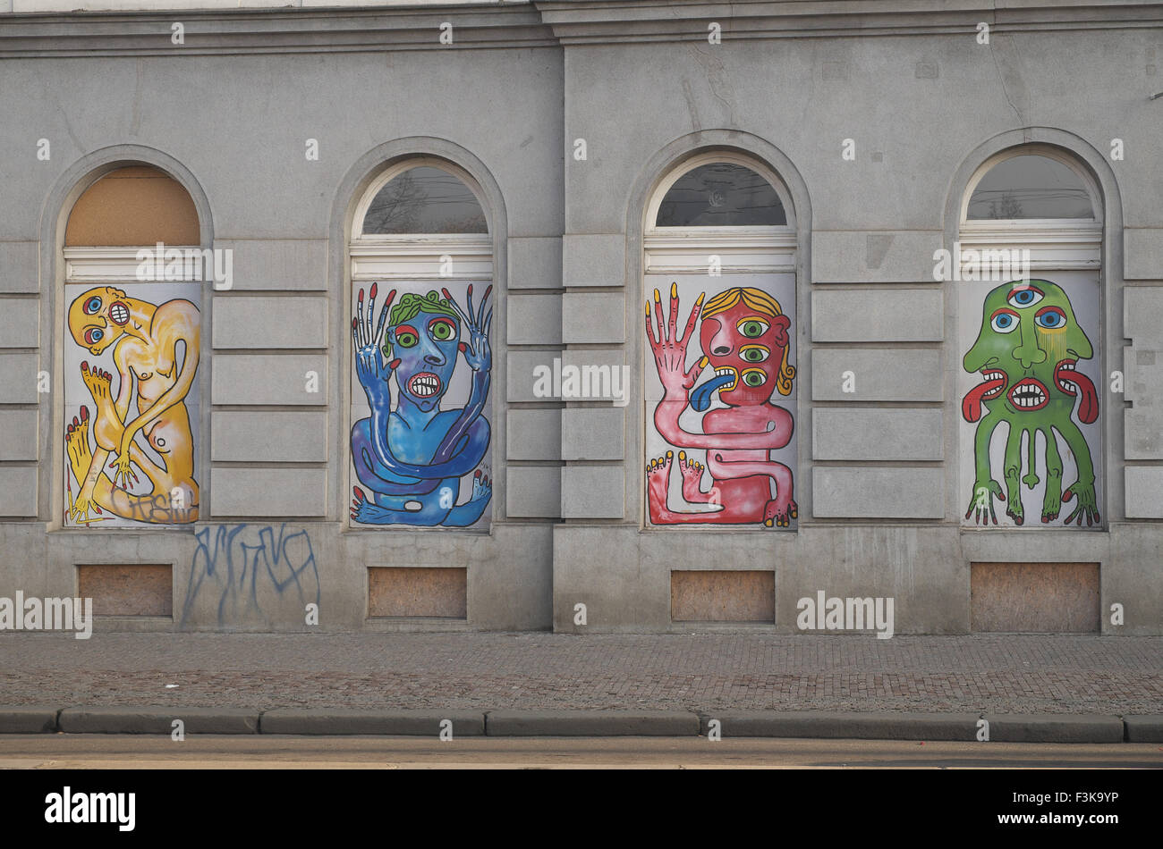 Graffiti painted on boarded up window panels, a back street, Prague ...