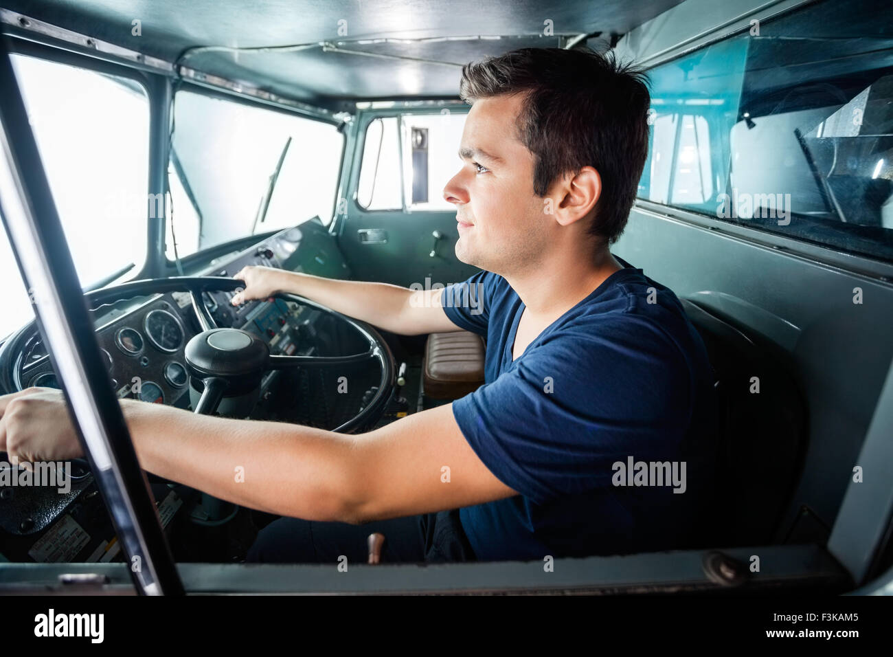Firefighter Driving Truck At Fire Station Stock Photo - Alamy