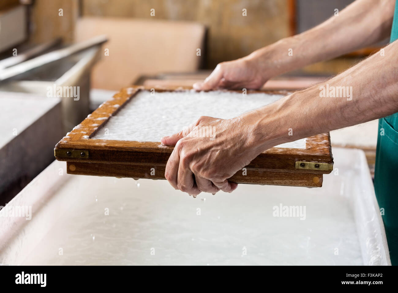 Cropped Image Of Worker Dipping Mold In Pulp And Water Stock Photo - Alamy