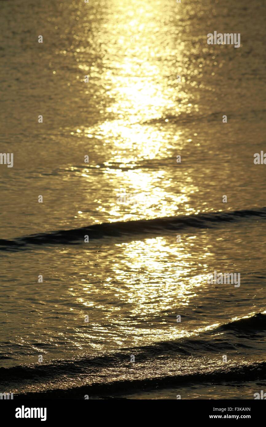 reflections of the sun in the early morning on the sea Stock Photo - Alamy