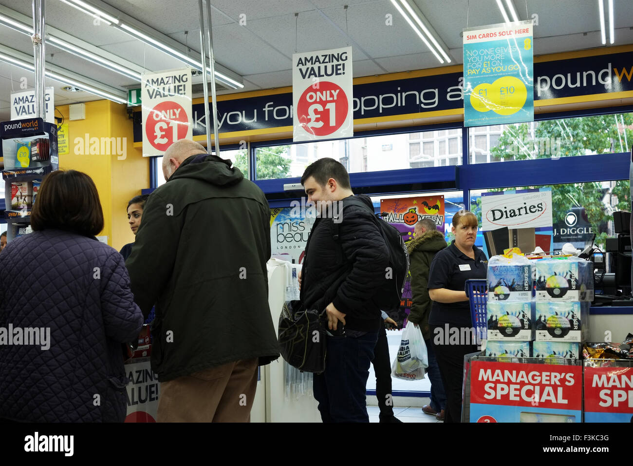 A pound discount store with £1 signs & discounted goods on racks or ...