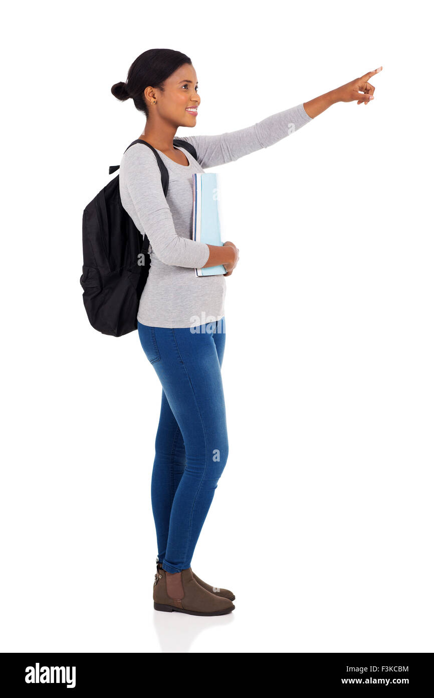 side view of African university student pointing on white background ...