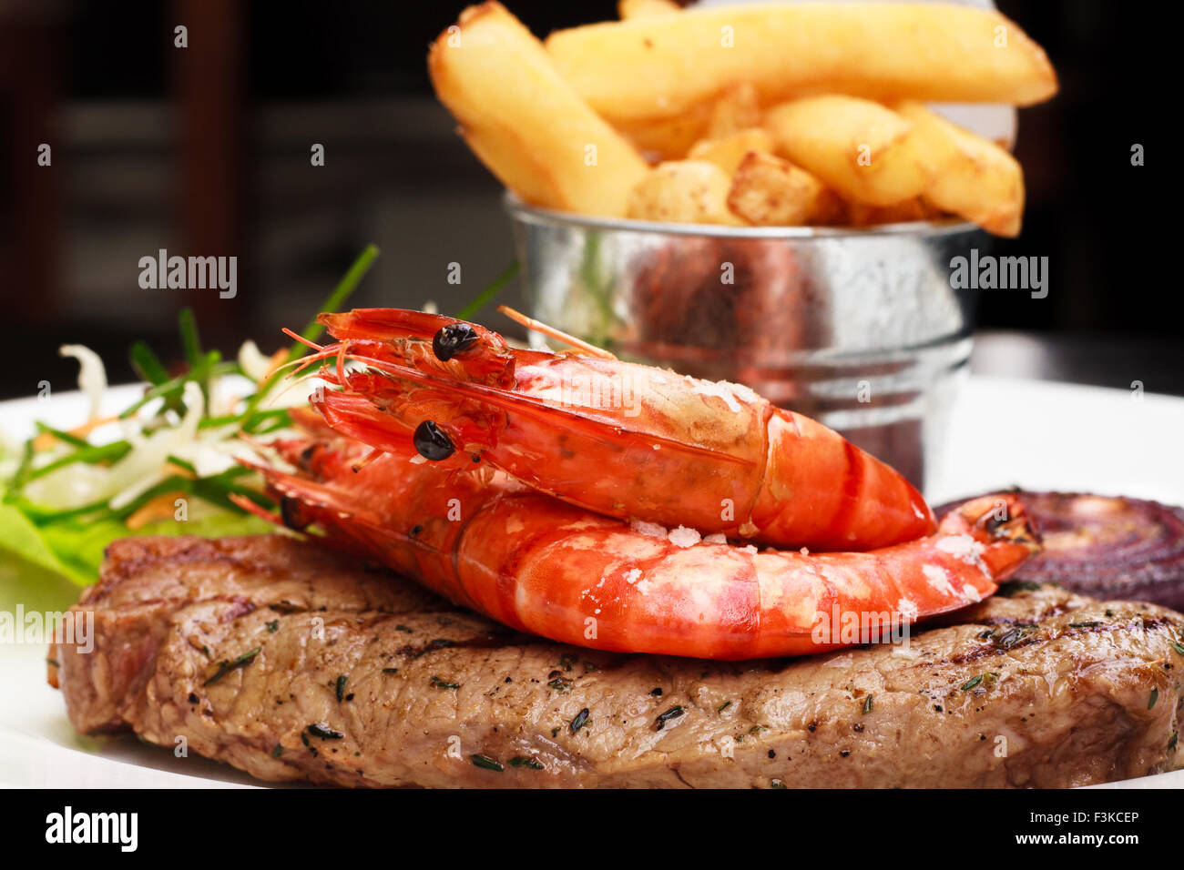 Surf and turf ( Steak and King Prawn served with fries and Asian slaw ...