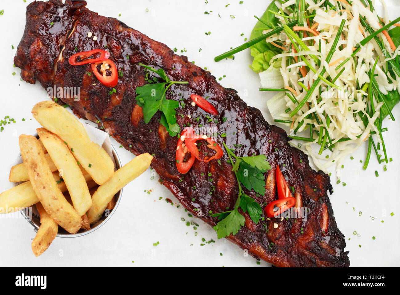 BBQ Rack of Ribs with salted fries and Asian slaw Stock Photo - Alamy
