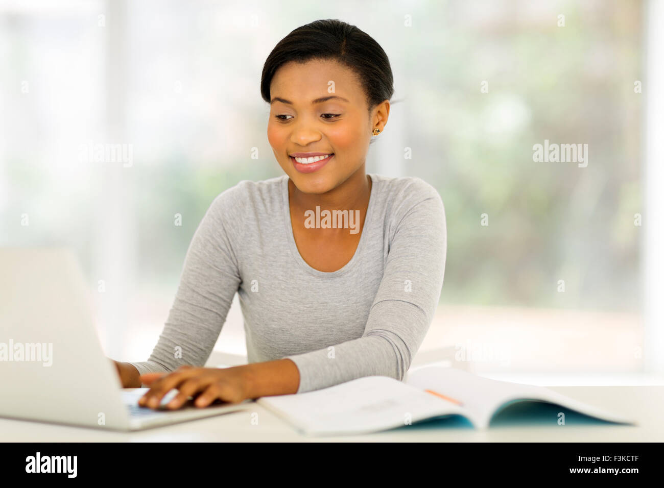 happy African college student using laptop computer Stock Photo - Alamy