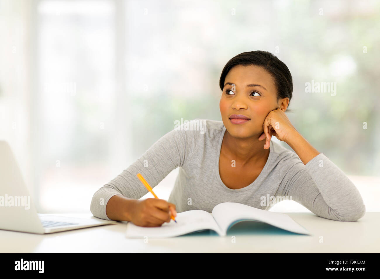 thoughtful young woman studying at home Stock Photo - Alamy