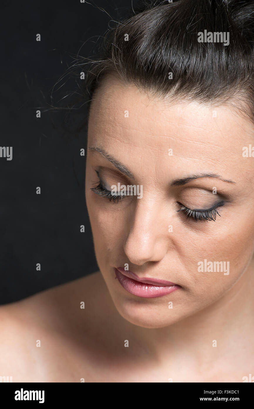 woman with her eyes looking down Stock Photo - Alamy