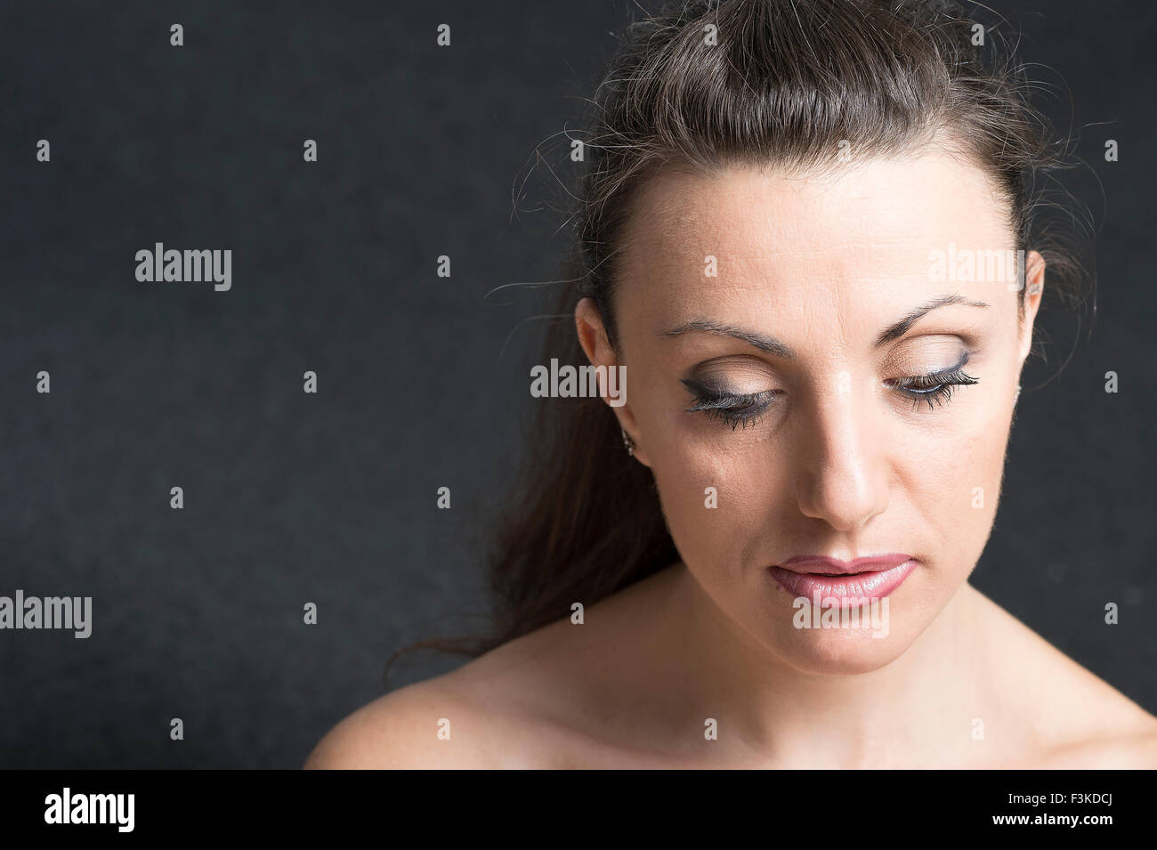 woman with her eyes looking down Stock Photo - Alamy