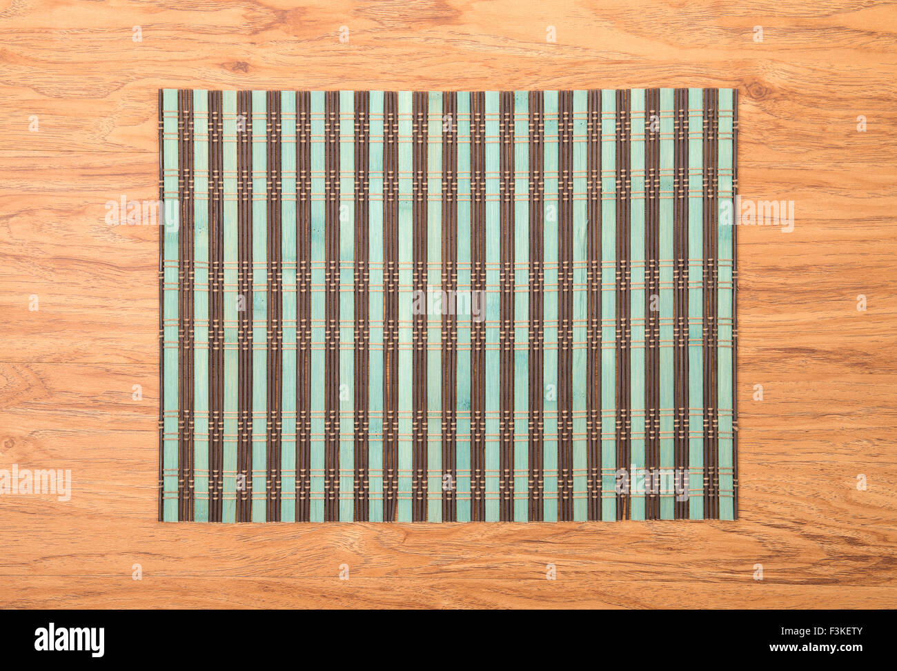 Bamboo place mat on wooden deck table Stock Photo - Alamy