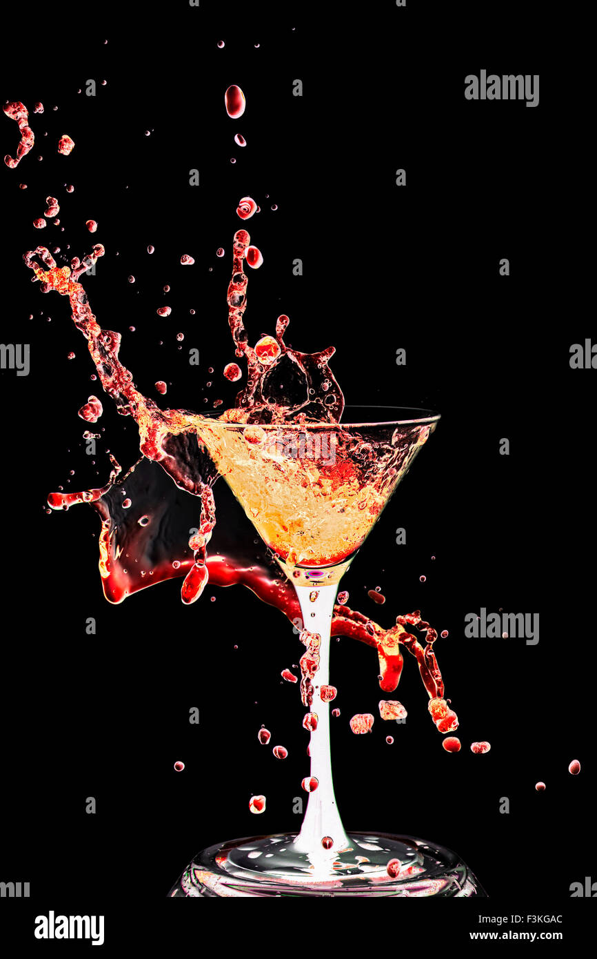 Abstract art. Cocktail glass with splashes of liquid isolated on a ...