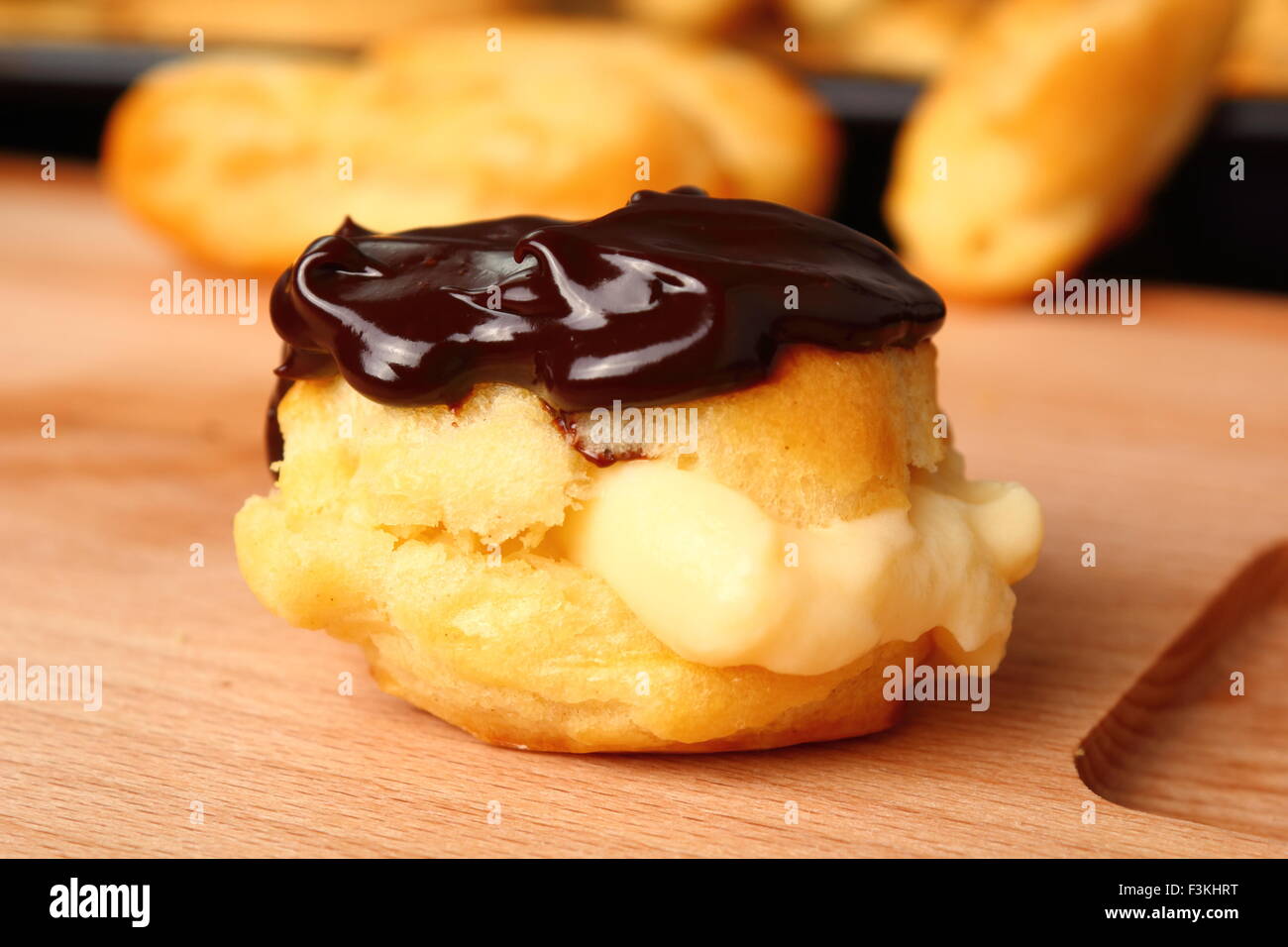 Pouring melted chocolate. Making Eclair Stock Photo - Alamy