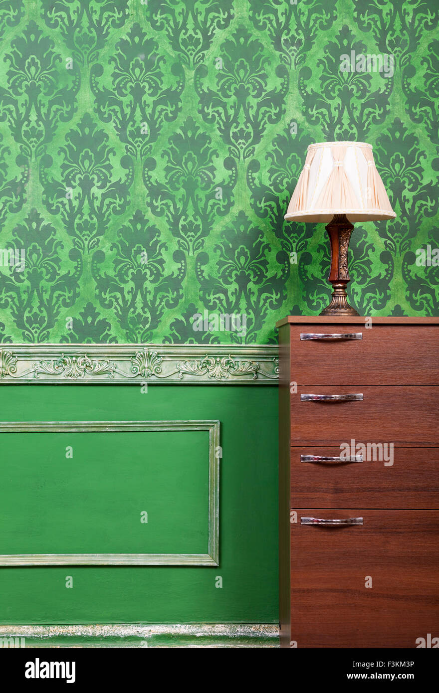 Lamp on furniture in green vintage interior. Rich rococo period home ...