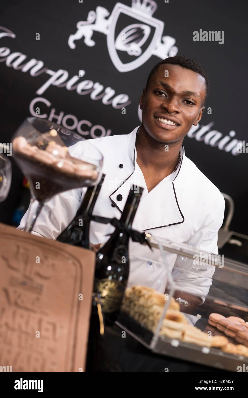 Smiling man promoting chocolate products at the Sunday Organic Food ...