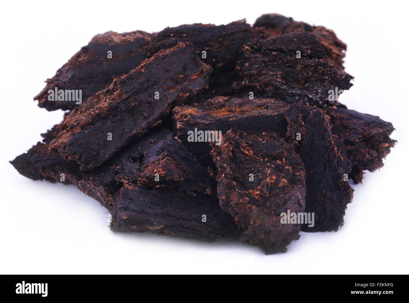 Close up of peat block over white background Stock Photo - Alamy