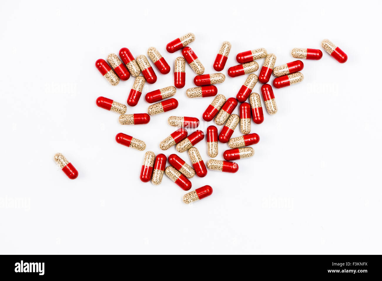 Many red and transparent medical capsulas, filled with yellow medicine ...