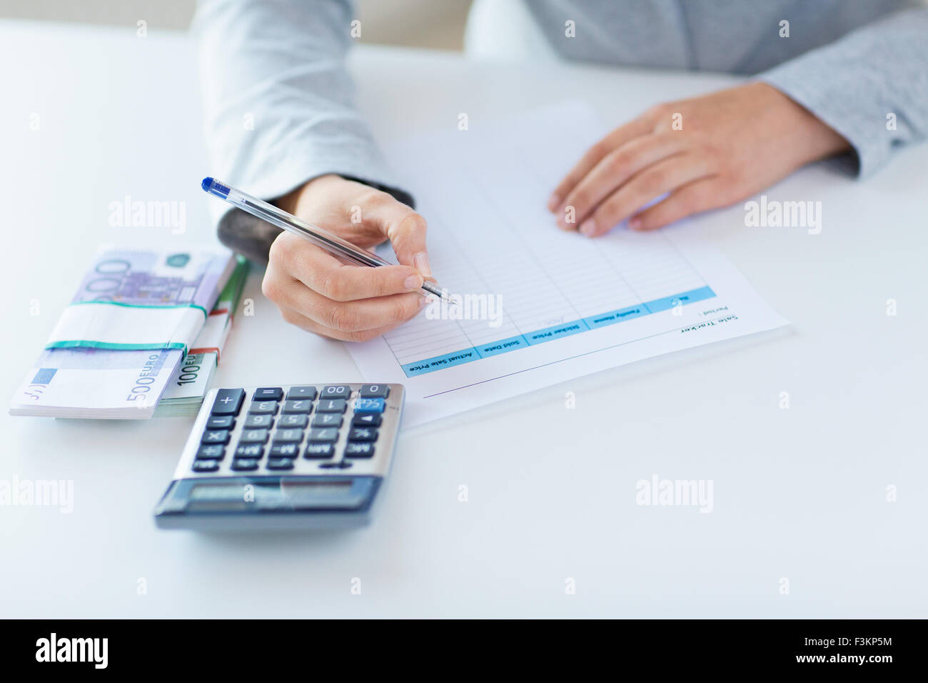 close up of hands counting money with calculator Stock Photo - Alamy