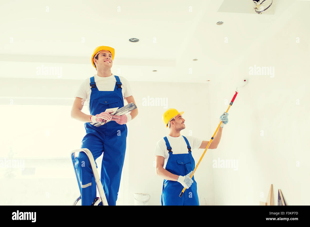 group of builders with tools indoors Stock Photo - Alamy