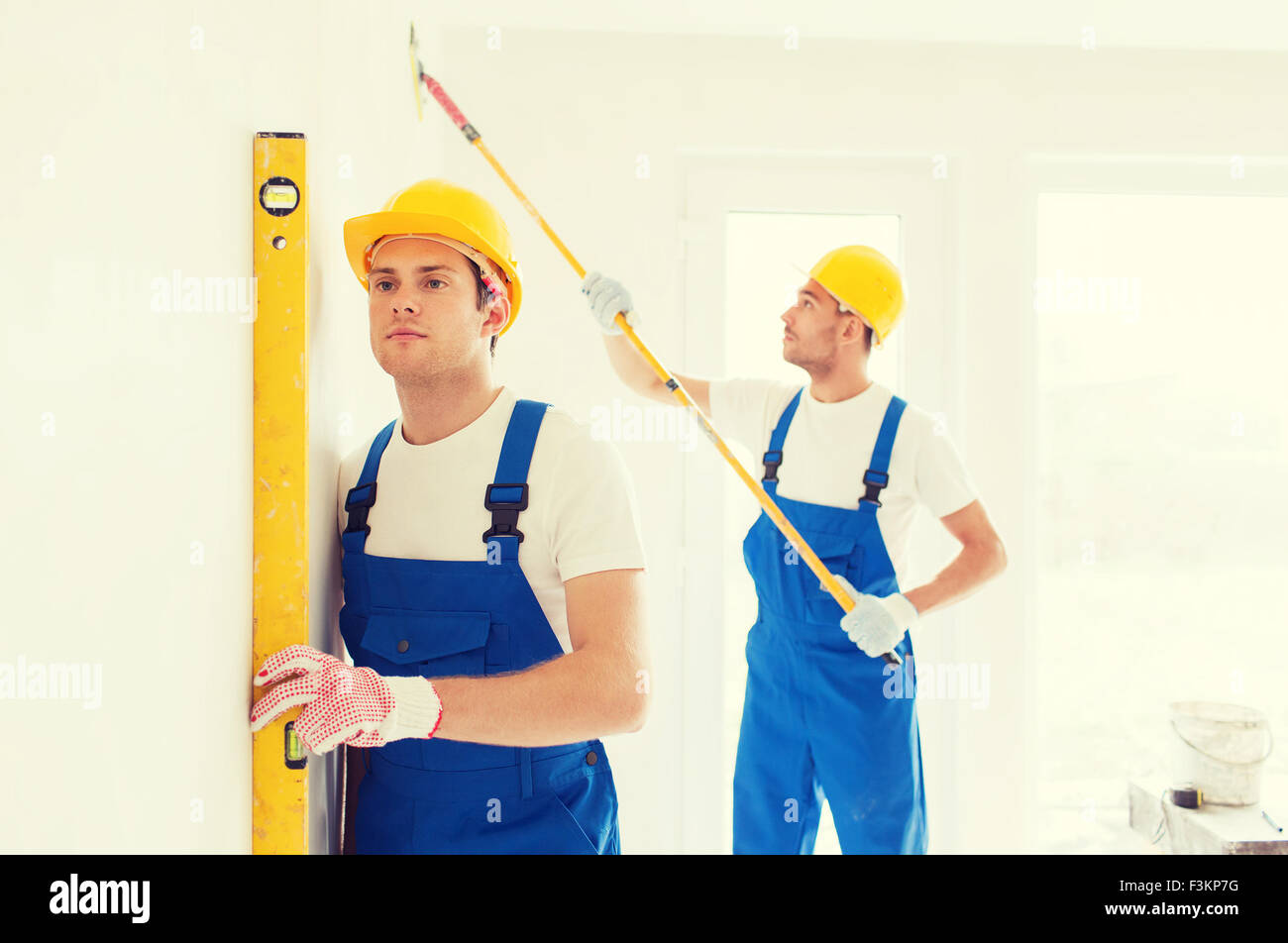 group of builders with tools indoors Stock Photo - Alamy