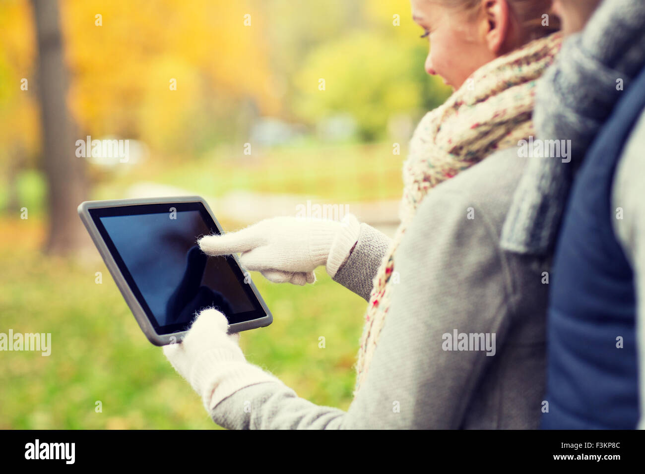 couple hands in gloves with tablet pc outdoors Stock Photo - Alamy