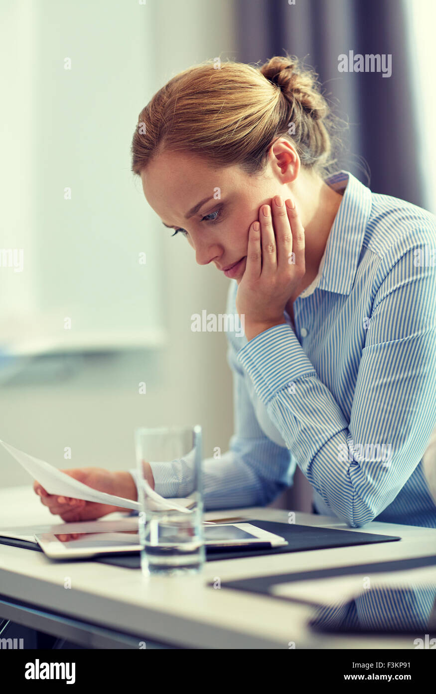 Businesswoman reading documents thinking hi-res stock photography and ...