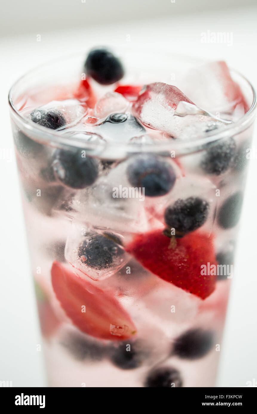 close up of fruit water with ice cubes in glass Stock Photo - Alamy