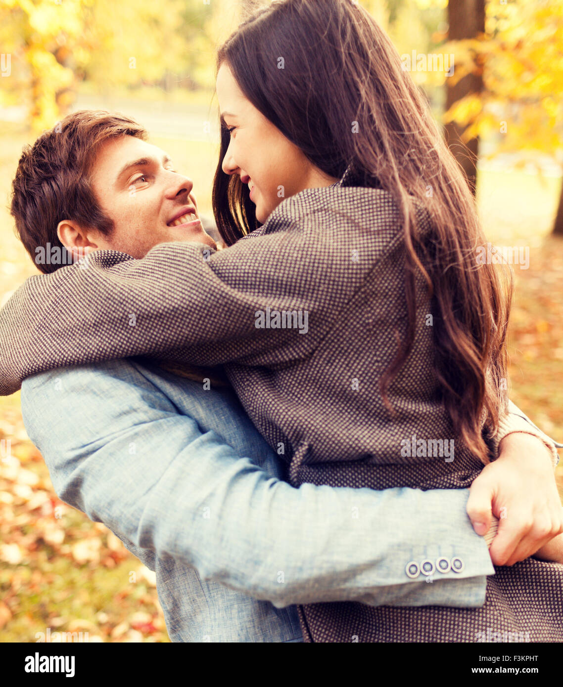 smiling couple hugging in autumn park Stock Photo - Alamy