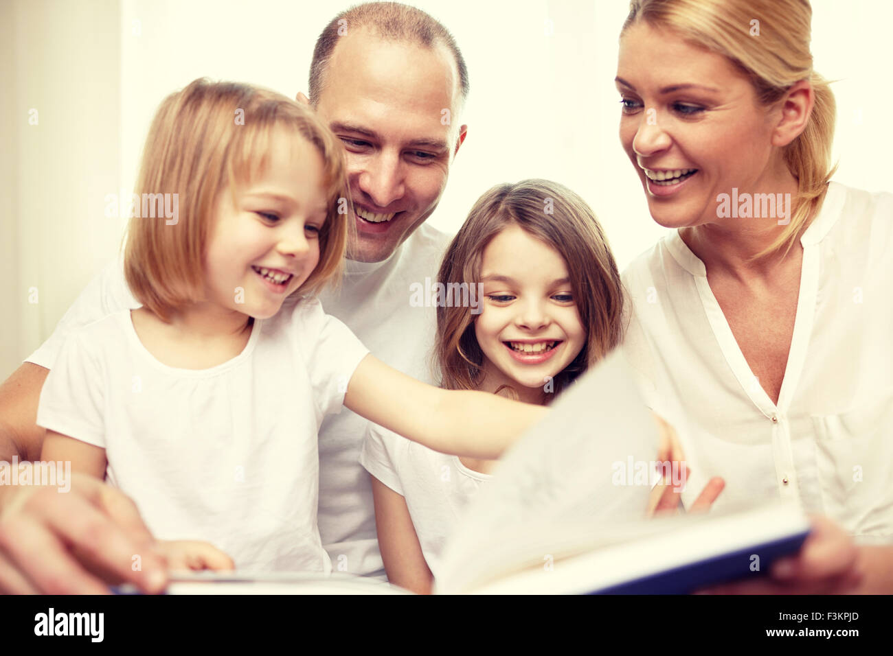 happy family reading book at home Stock Photo - Alamy