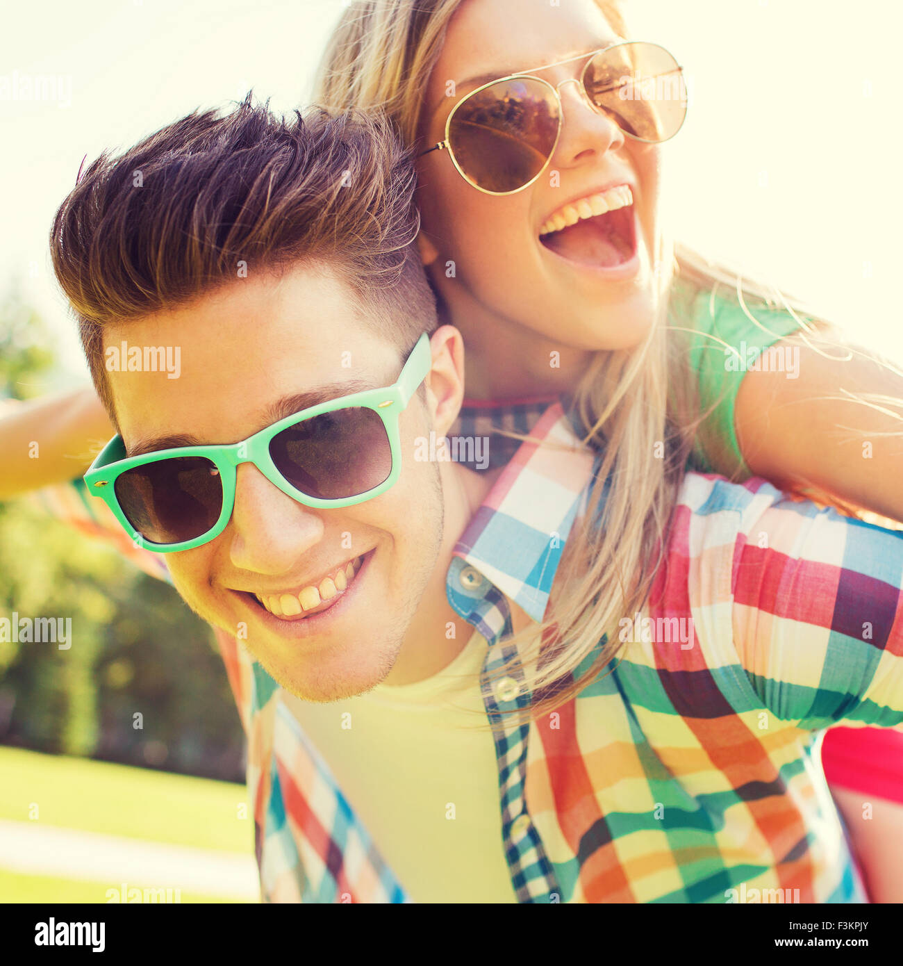 smiling couple having fun in park Stock Photo - Alamy