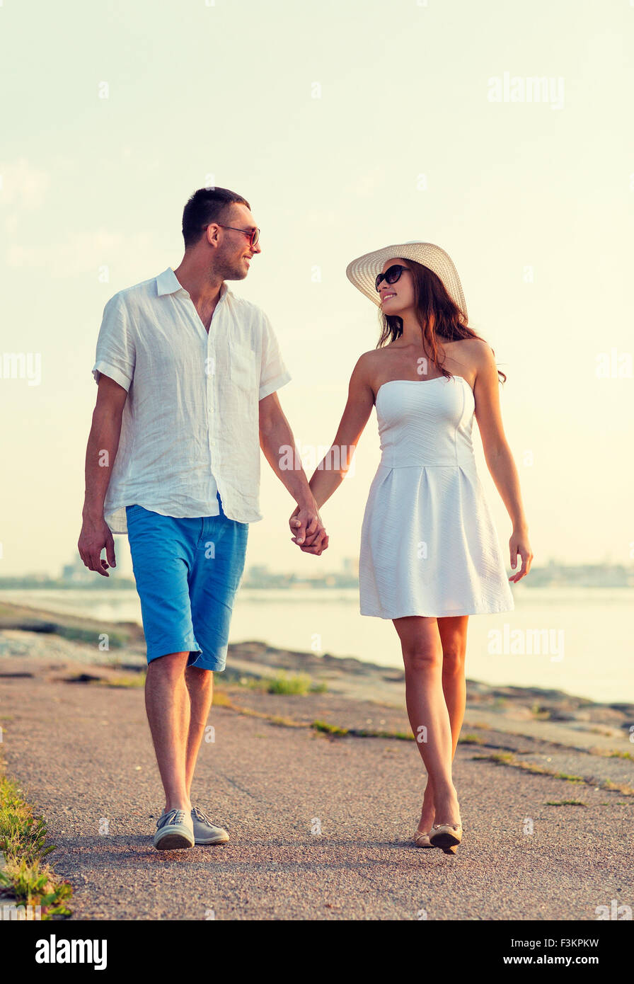 smiling couple walking outdoors Stock Photo - Alamy
