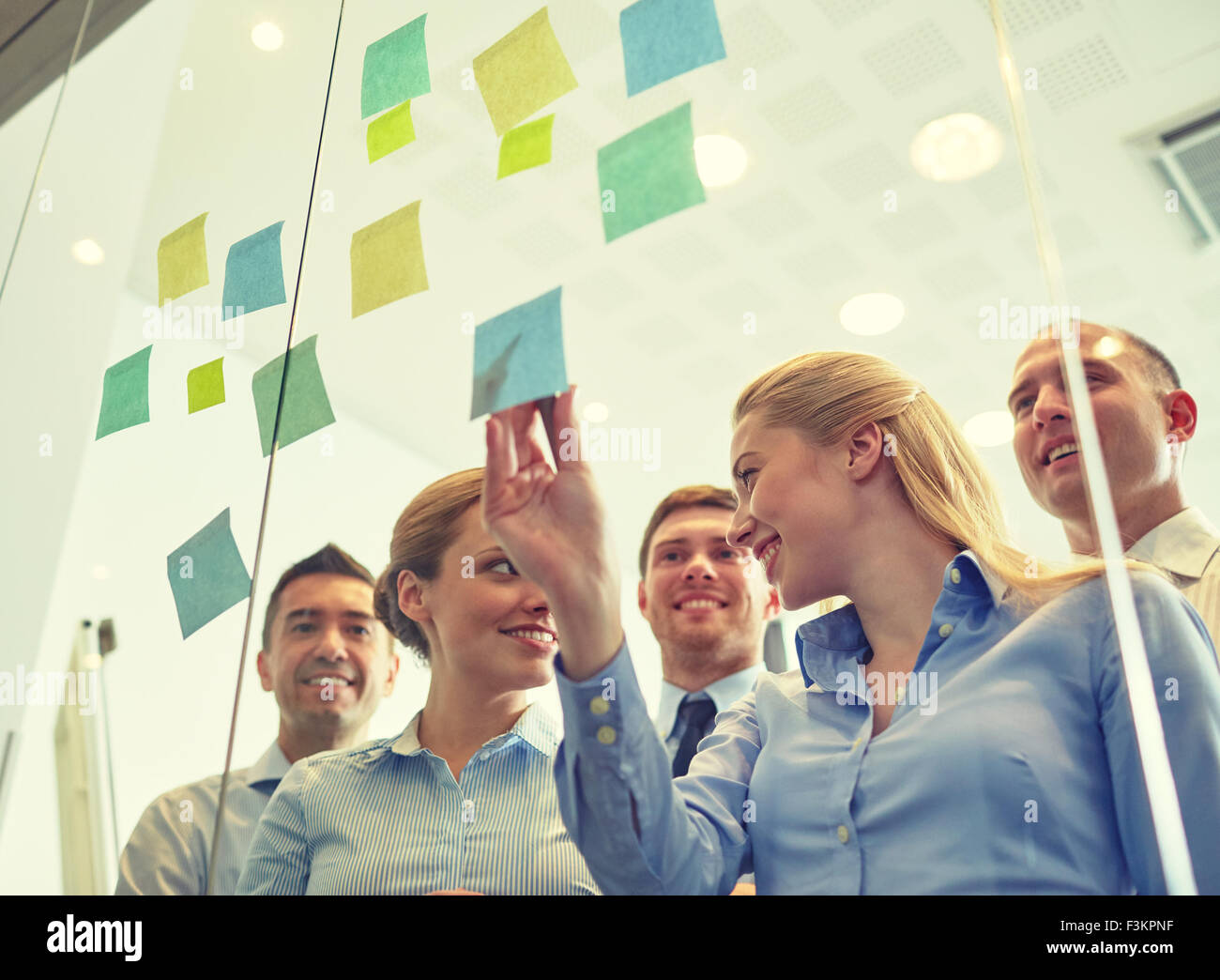 smiling business people with marker and stickers Stock Photo - Alamy