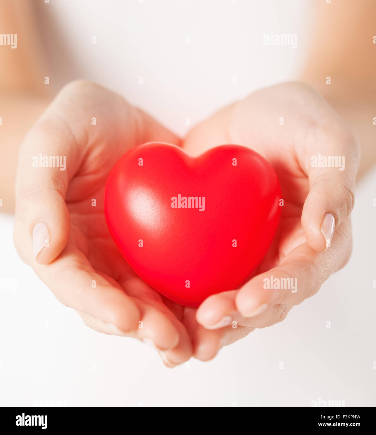 female hands with small red heart Stock Photo - Alamy