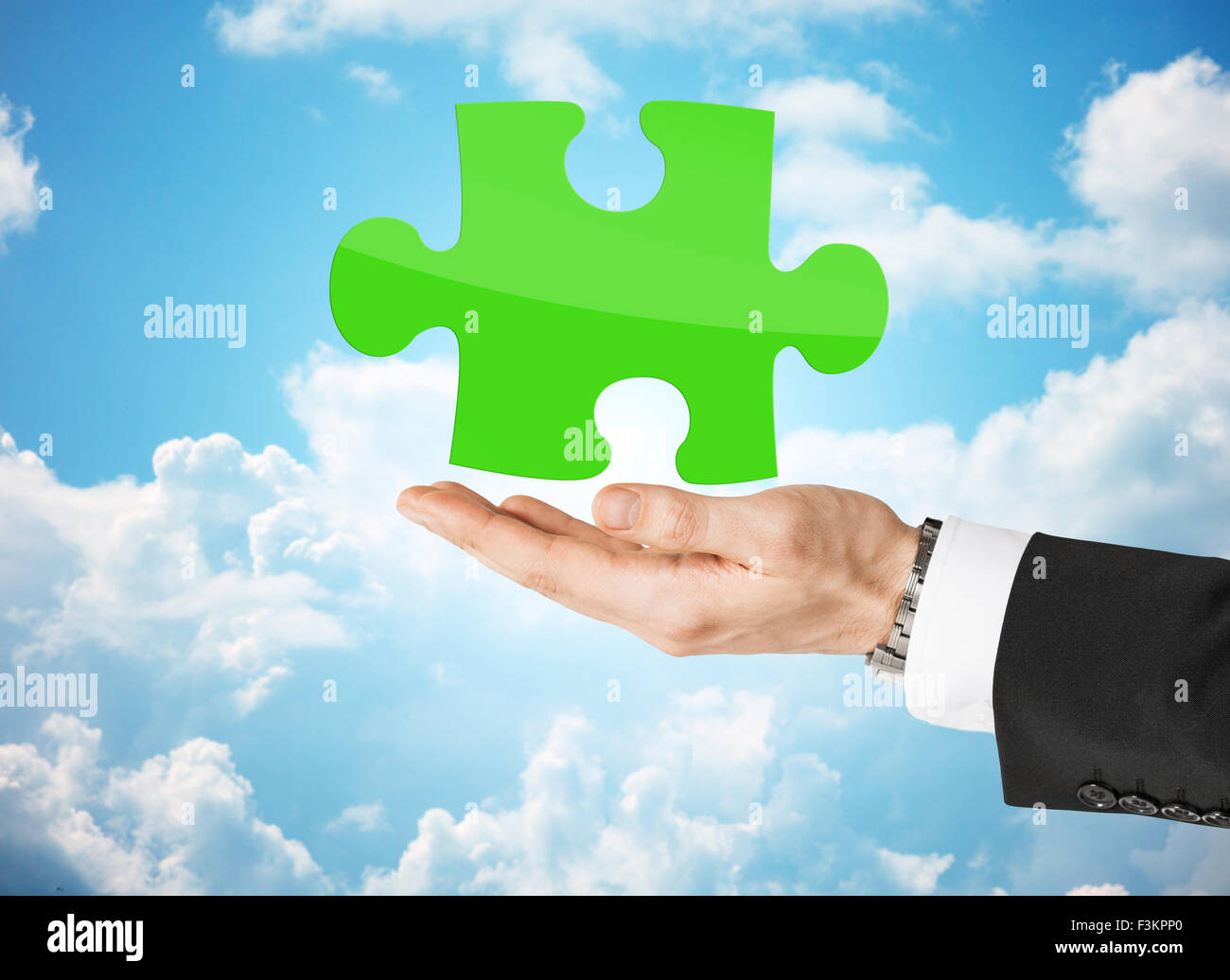 close up of man holding green puzzle piece Stock Photo - Alamy