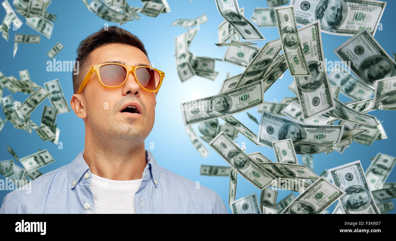 surprised man under dollar money rain Stock Photo - Alamy