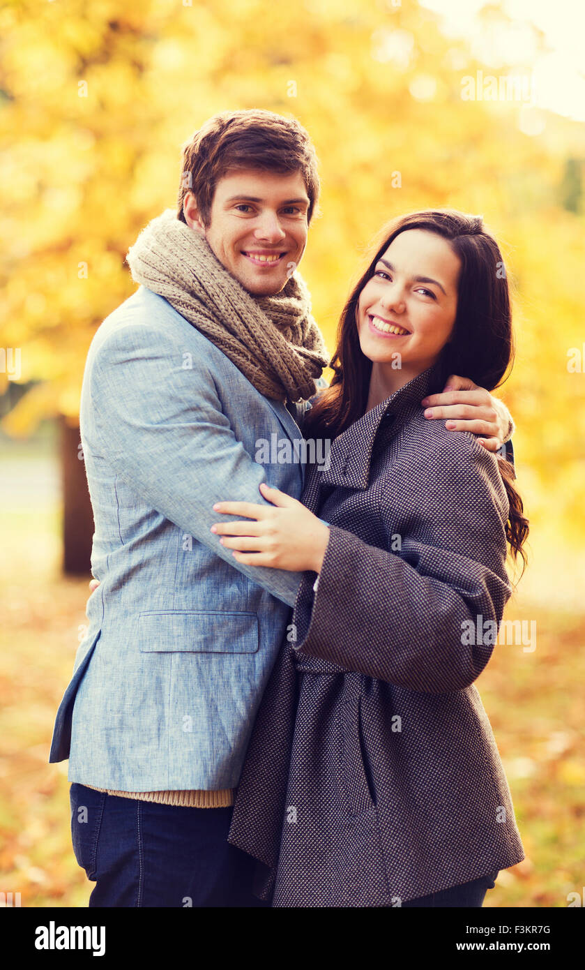 smiling couple hugging in autumn park Stock Photo - Alamy